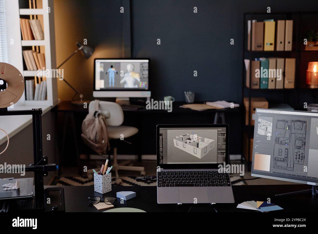 Design studio with various computer screens displaying 3D model ...