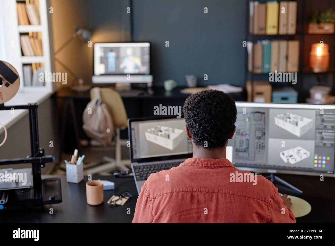 Person working on 3D design project with two computer monitors and a 3D ...
