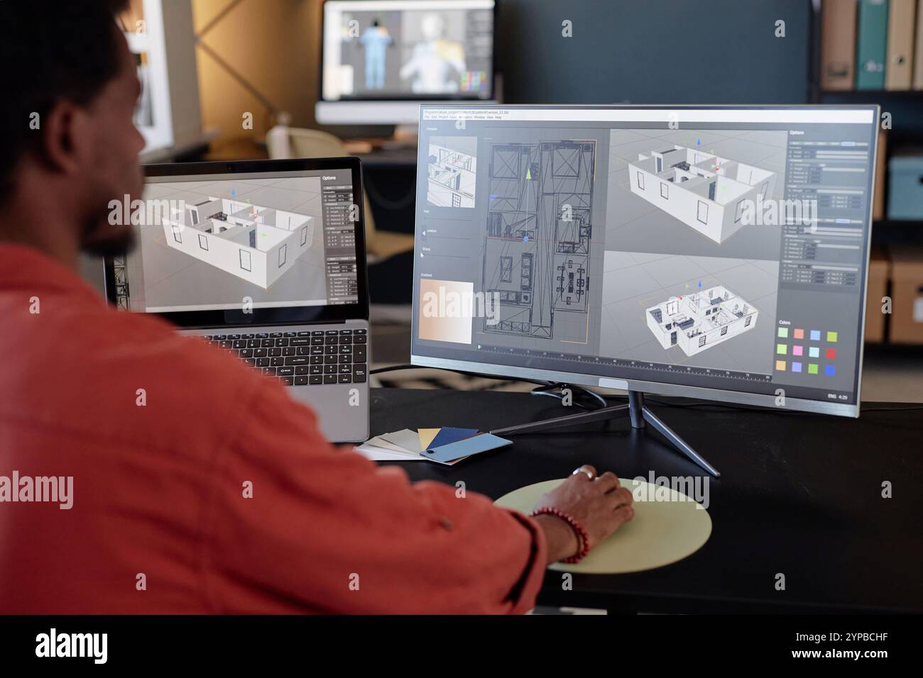Person analyzing architectural designs on computer screens at office ...