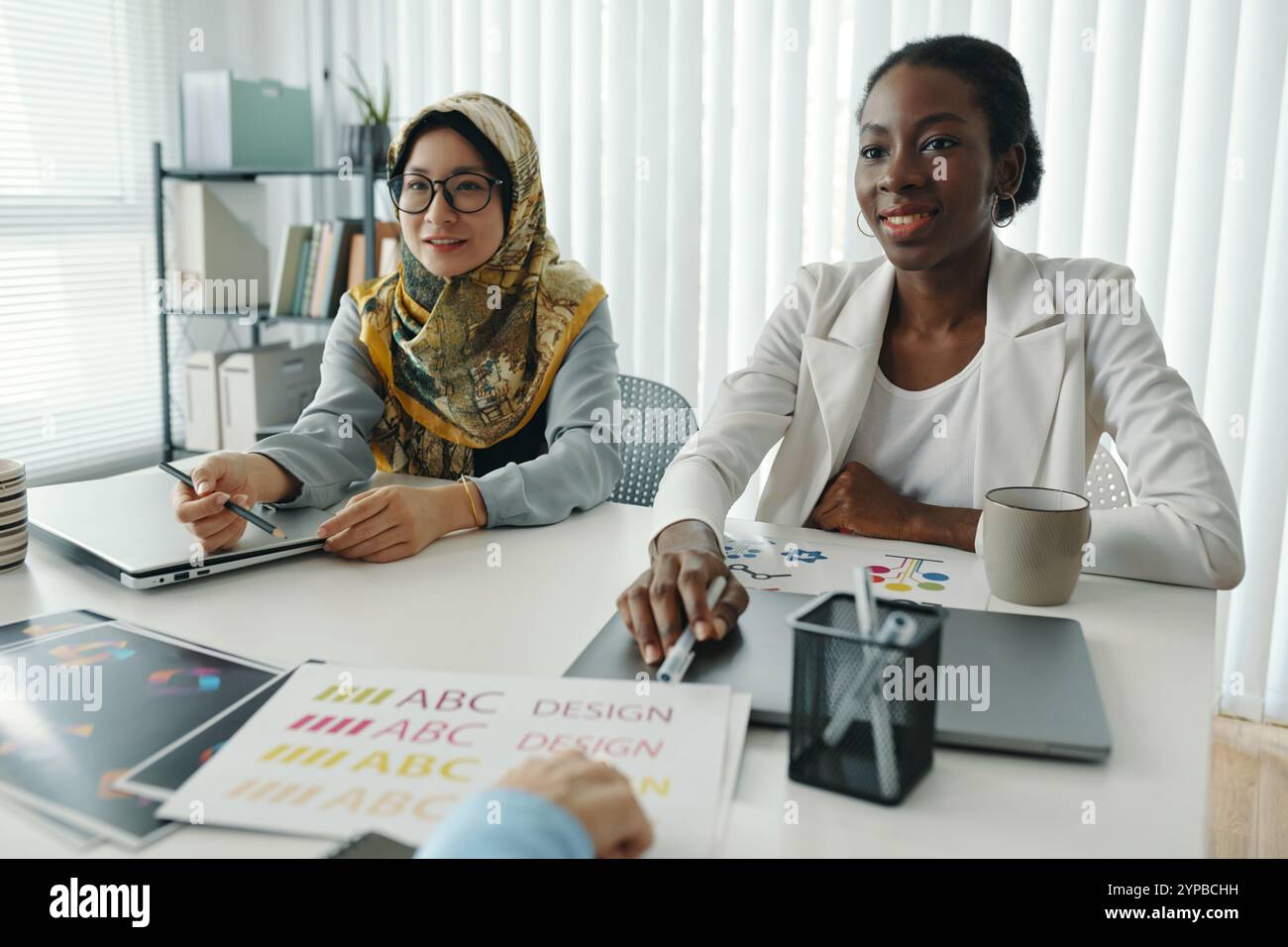 Discussing Design Strategies Around Office Table Stock Photo - Alamy