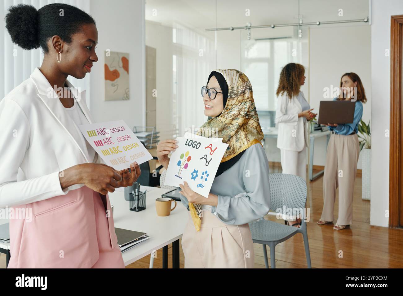 Discussing Graphic Design Concepts in Office Setting Stock Photo - Alamy