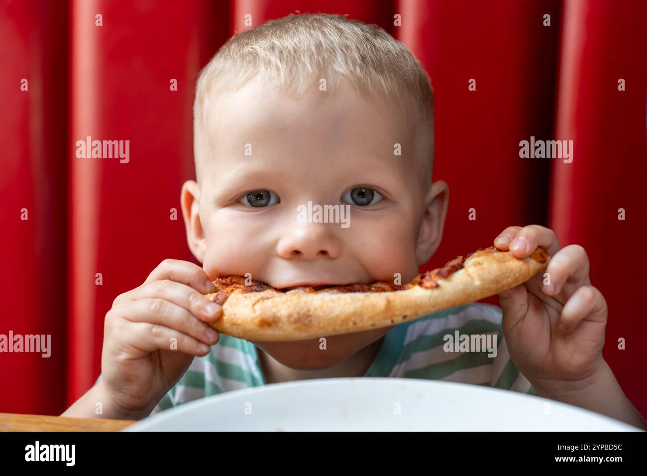 child enjoys eating the pizza crust, very tasty pizza at the cafe ...