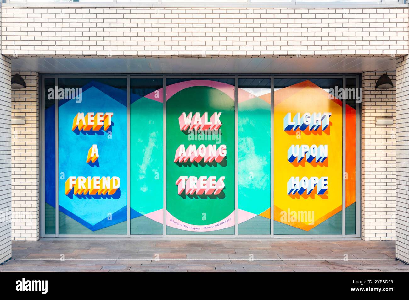 Colorful inspirational messages displayed on a vibrant geometric mural ...