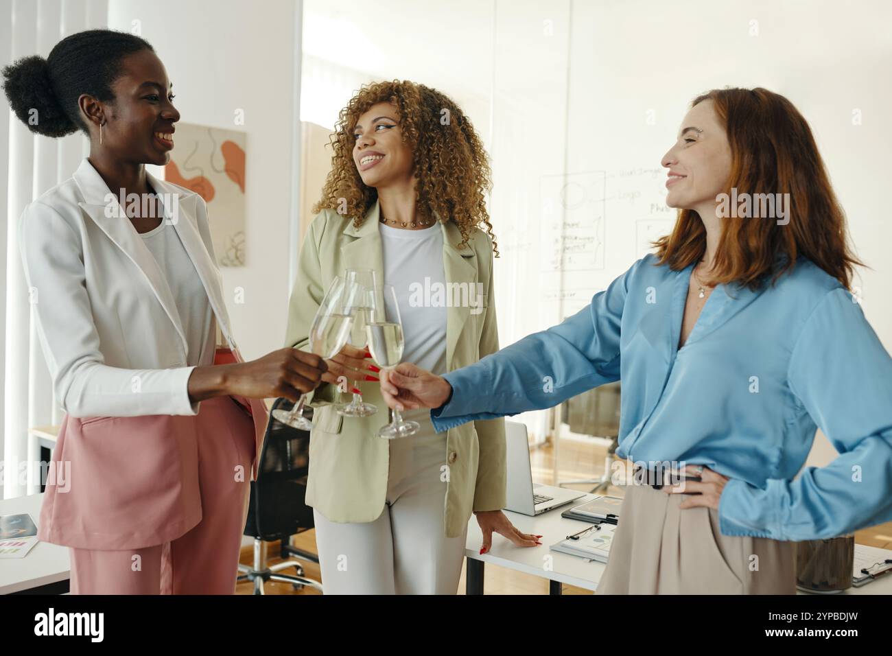 Celebrating Successful Collaboration in Modern Office Stock Photo - Alamy
