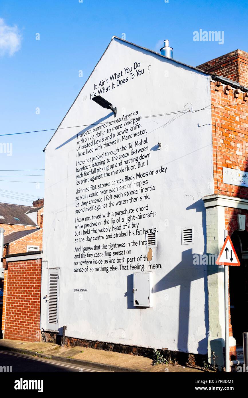 Street art mural on a brick wall featuring poem about life& societal ...