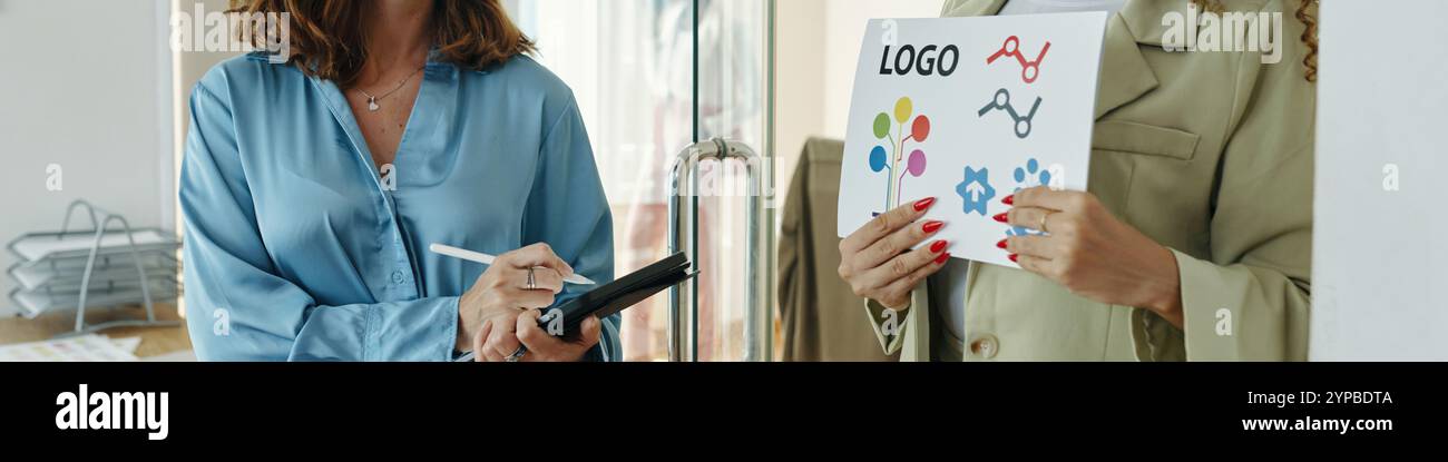 Discussing Logo Design Ideas in Modern Office Stock Photo - Alamy