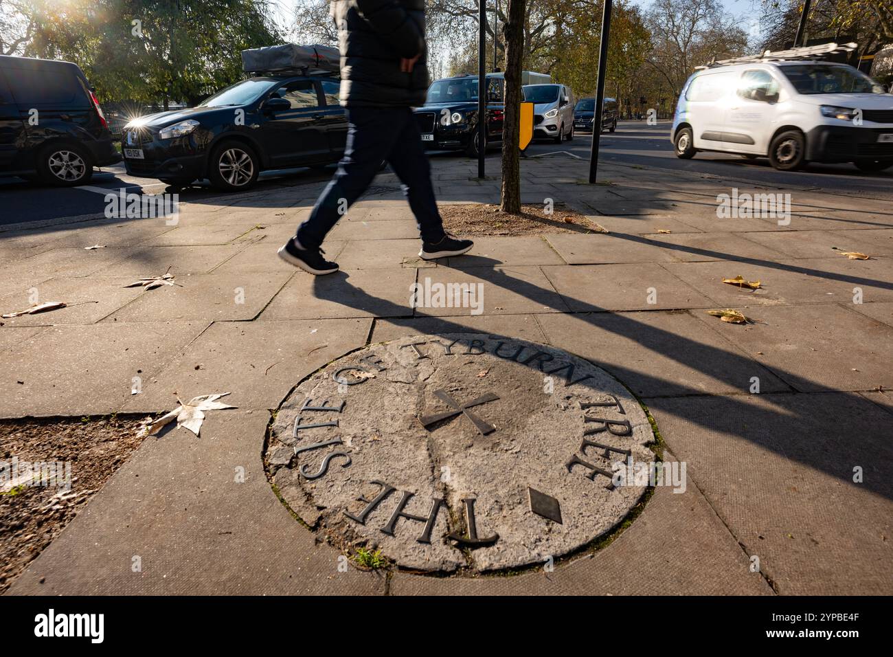 A circular plaque embedded into the pavement on a traffic island at the ...