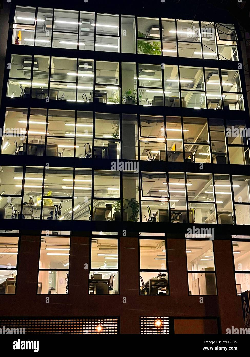 Facade of office building at night Stock Photo - Alamy