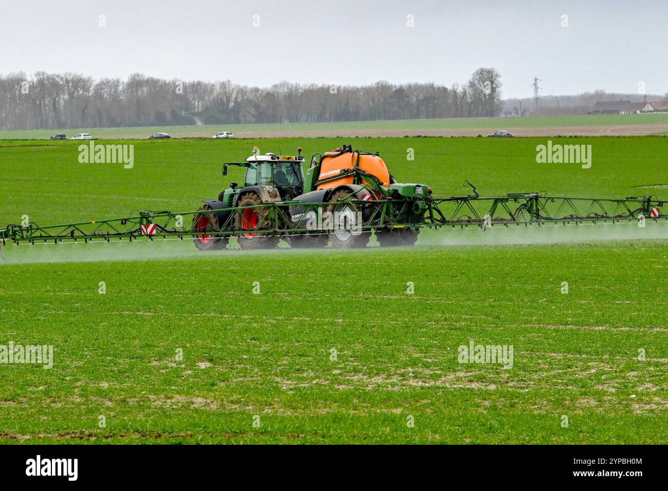 Phytosanitary treatment on an agricultural parcel. Tractor with a ...
