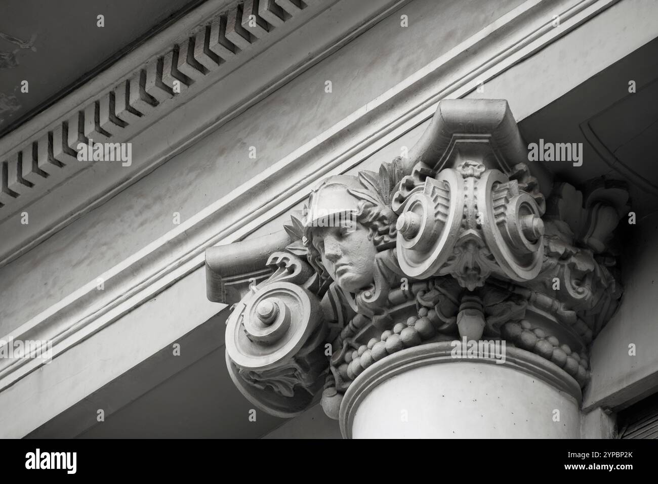 A pillar with a statue of a woman on top. The statue is of Athena. The ...
