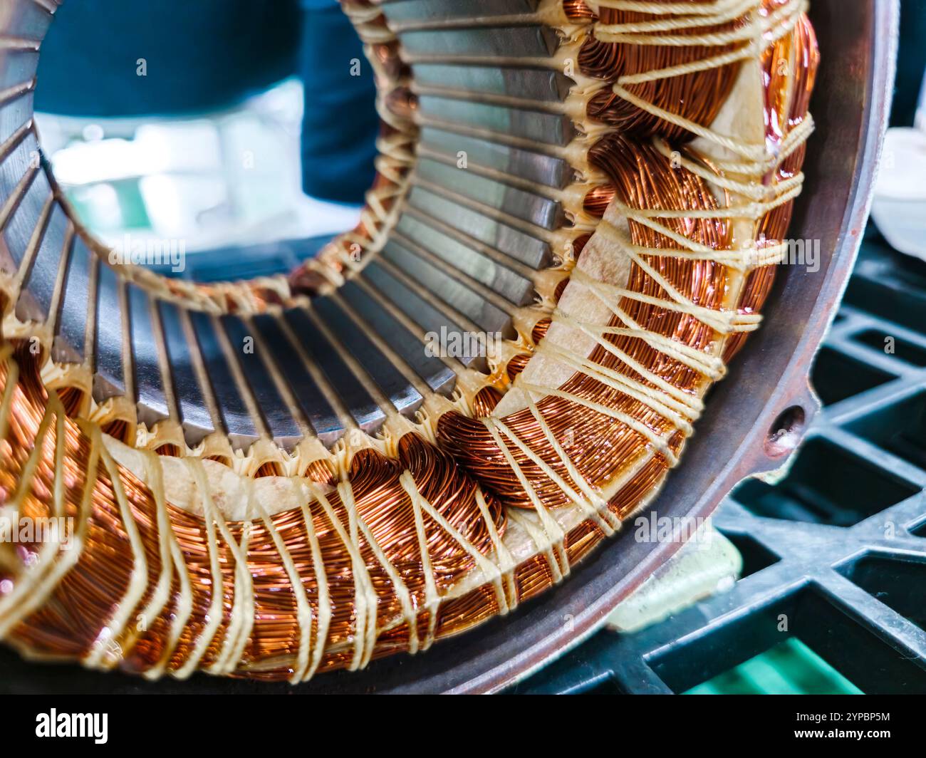 A brown wire is wrapped around a metal object. The wire is twisted and ...