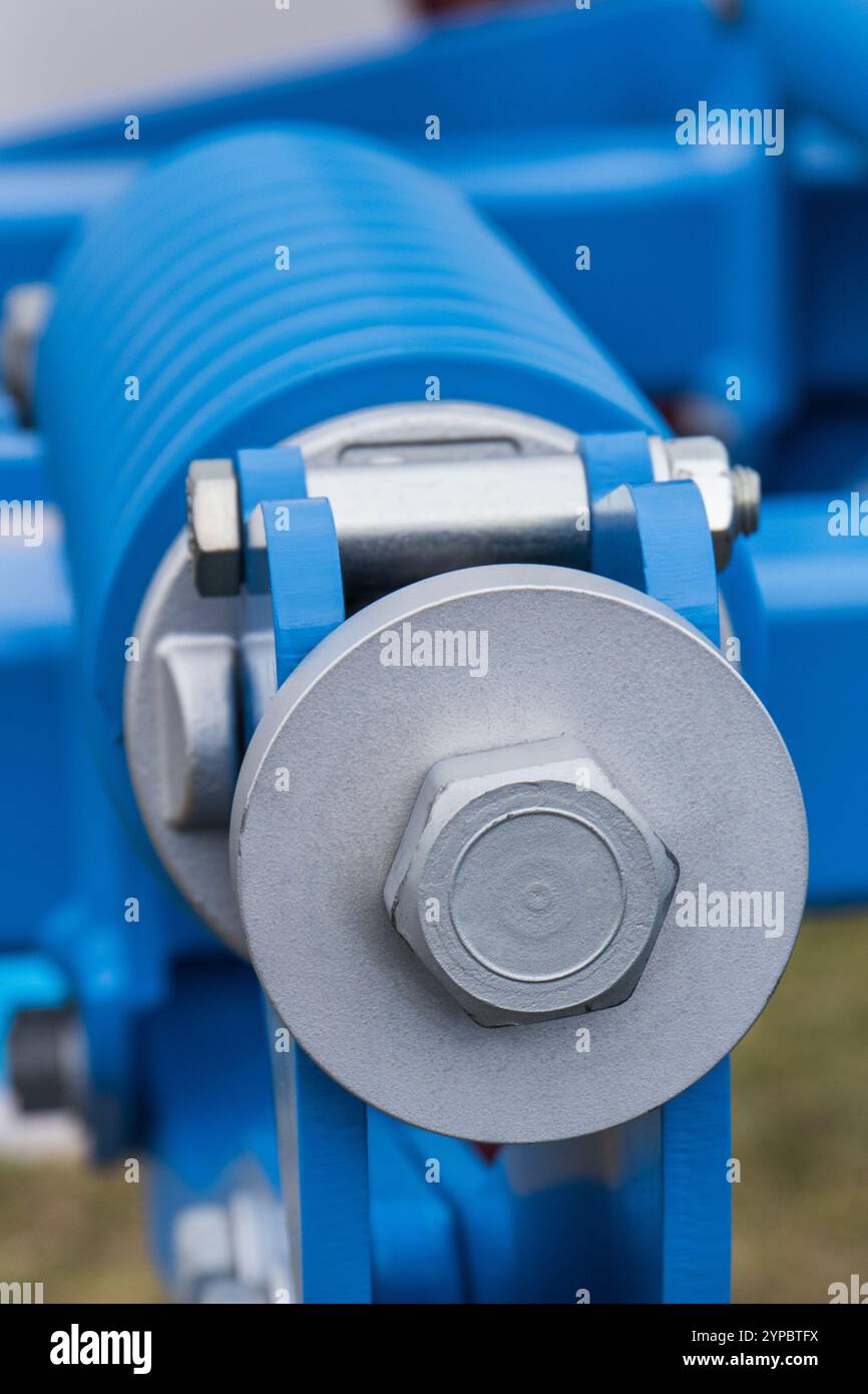 Blue hard spring made of steel. Detail and part of big industrial or ...