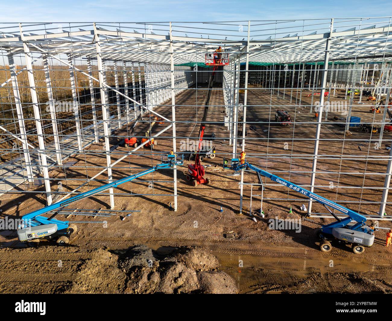 Construction workers are using lifting platforms to build the steel ...