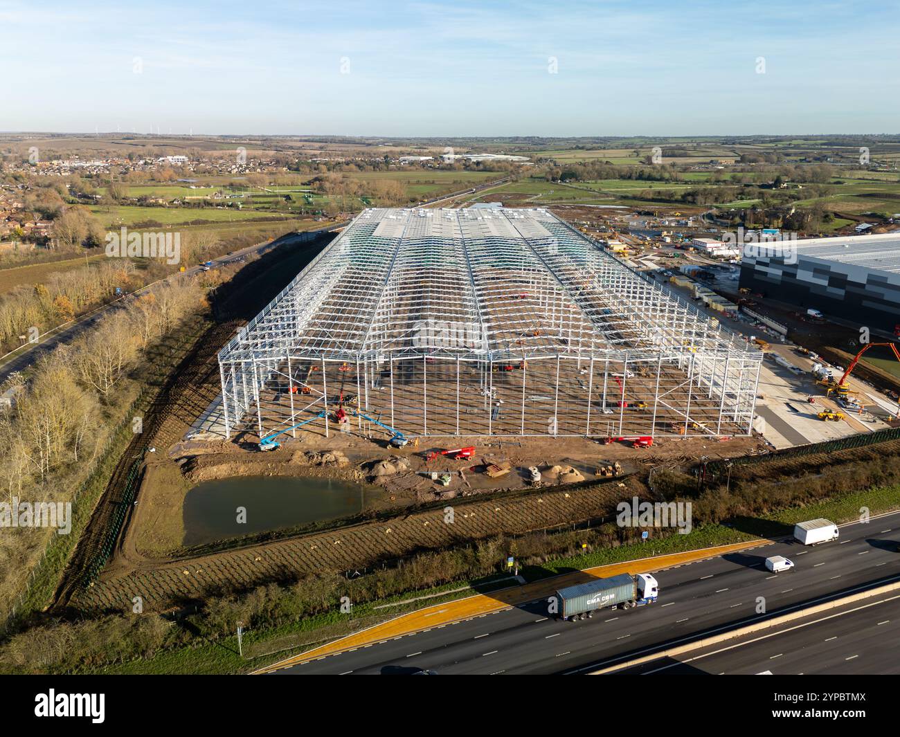 Aerial view of the steel frame of a large distribution center under ...