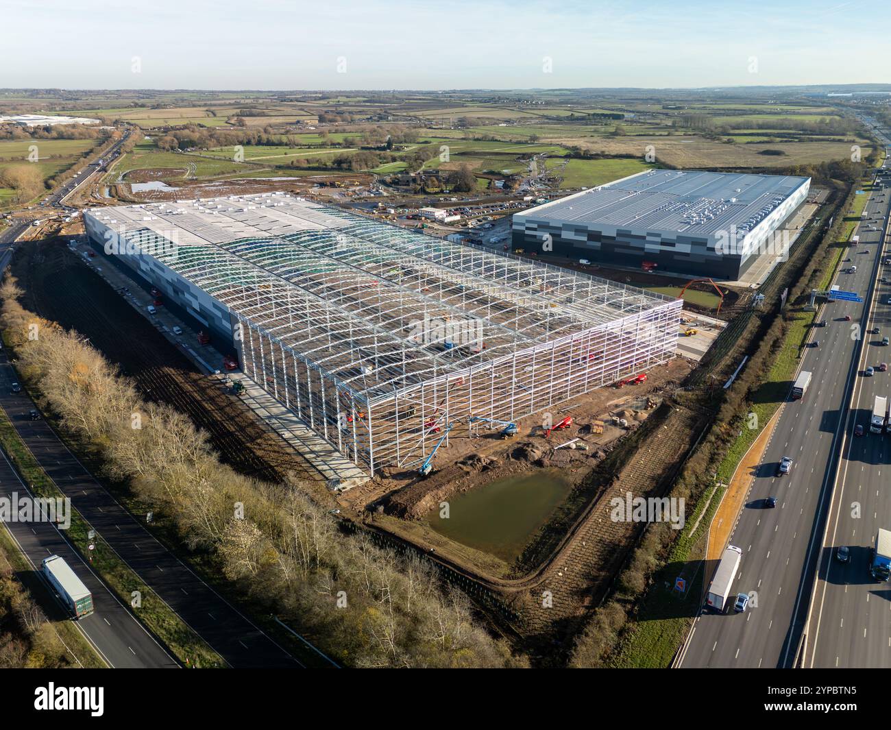 Aerial view of a large distribution warehouse with steel frame under ...