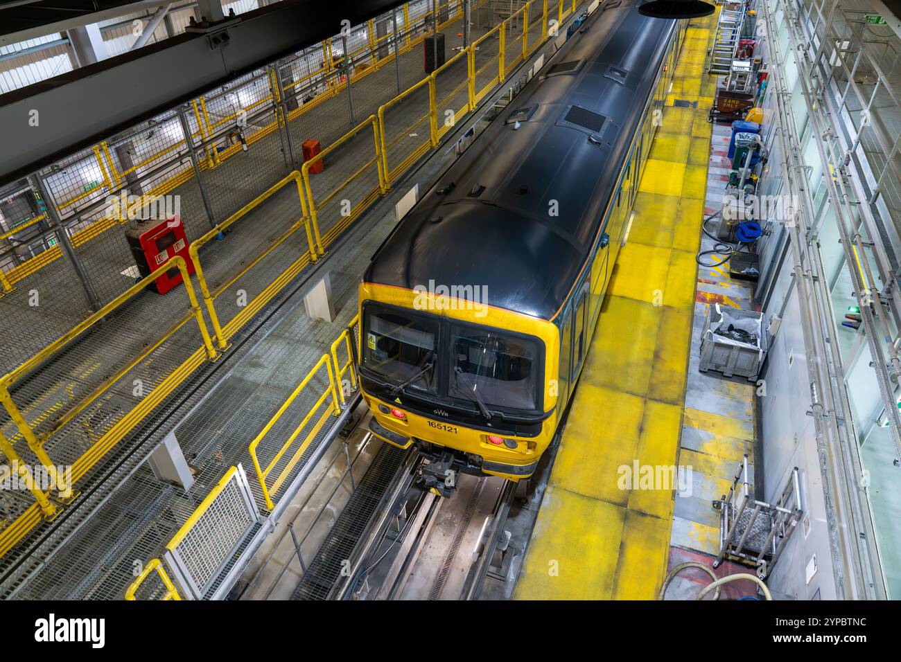 Elevated view of a train parked in a maintenance depot, showing the ...