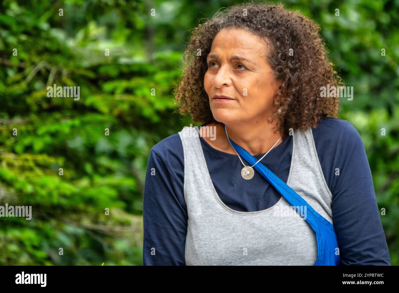 Beautiful South American woman, middle-aged with curly hair, and a lost ...