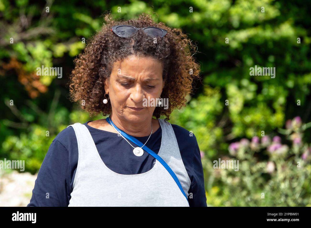 Latin American middle-aged lady, lost in her thoughts during a walk in ...