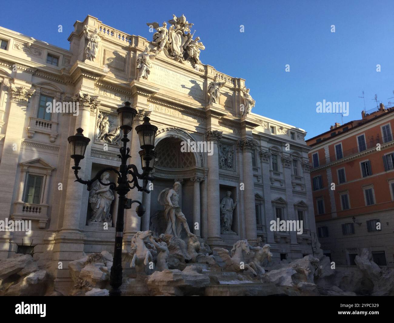 Visitors admire the stunning architecture of Trevi Fountain, surrounded ...
