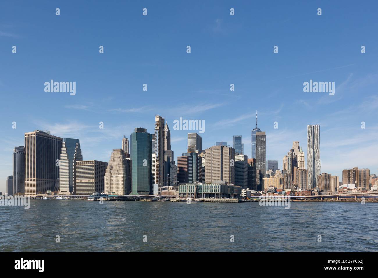 A stunning city skyline rises under a clear blue sky, its modern ...