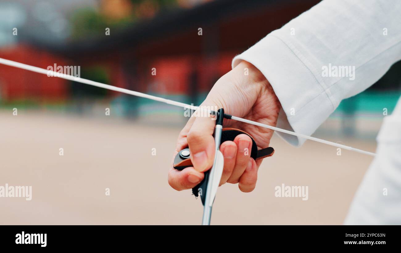 Archery, person and hands with arrow, bow or string for aim, skill or ...
