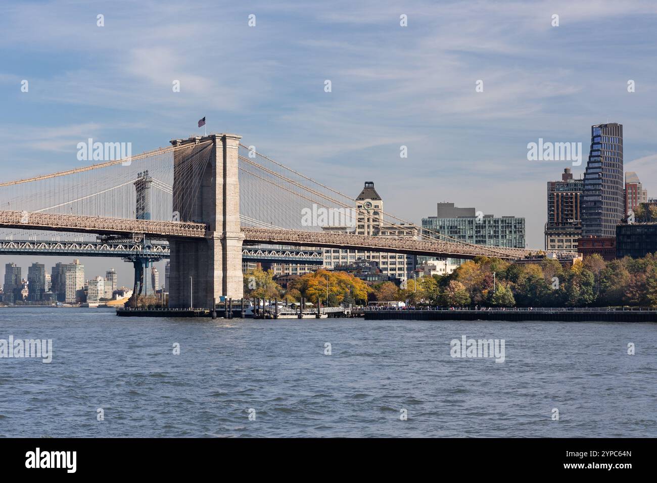 The Brooklyn Bridge stretches across the East River, linking Manhattan ...