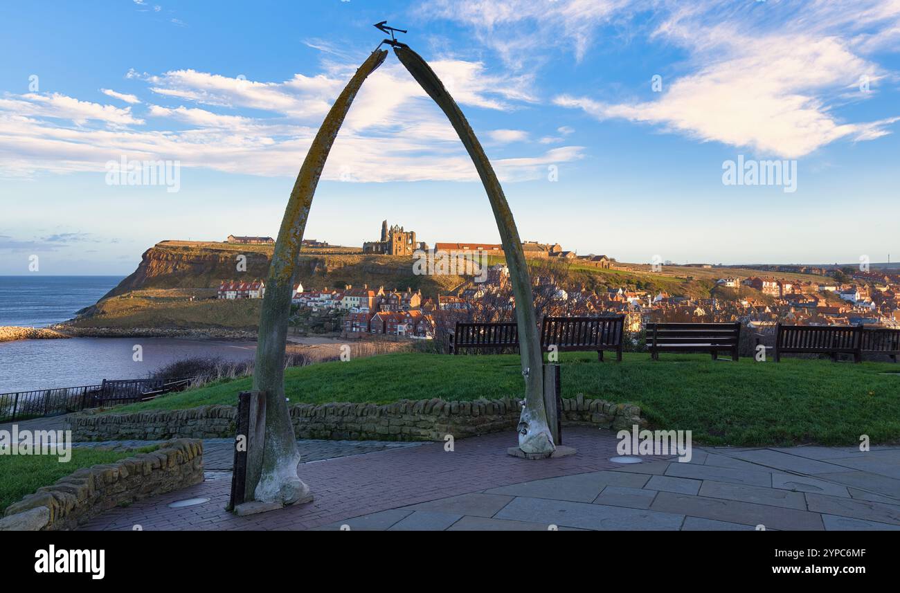 Late afternoon sun lights up the cottages on the East Cliff in Whitby ...