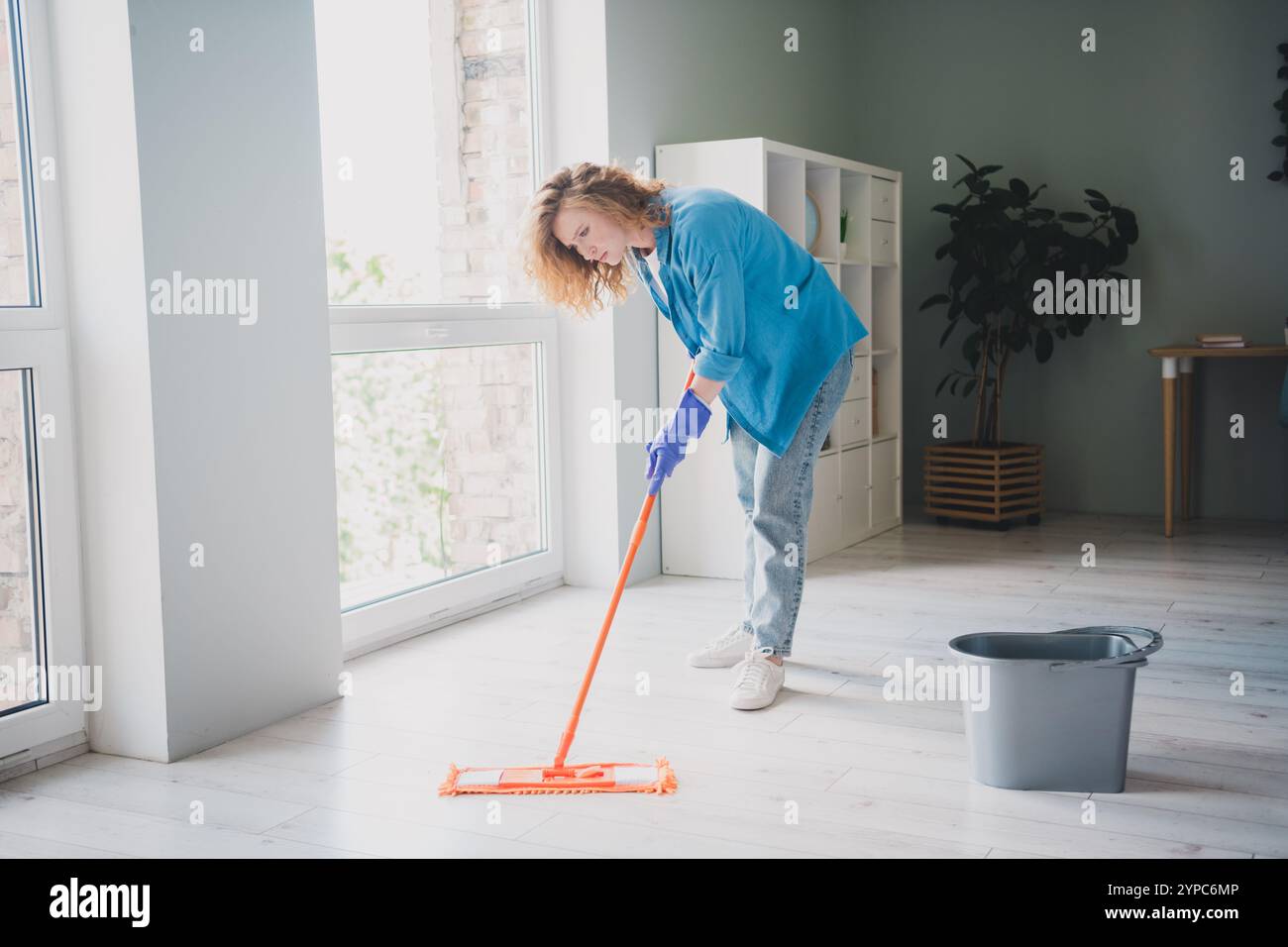 Full size photo of attractive young redhair woman stressed mopping ...