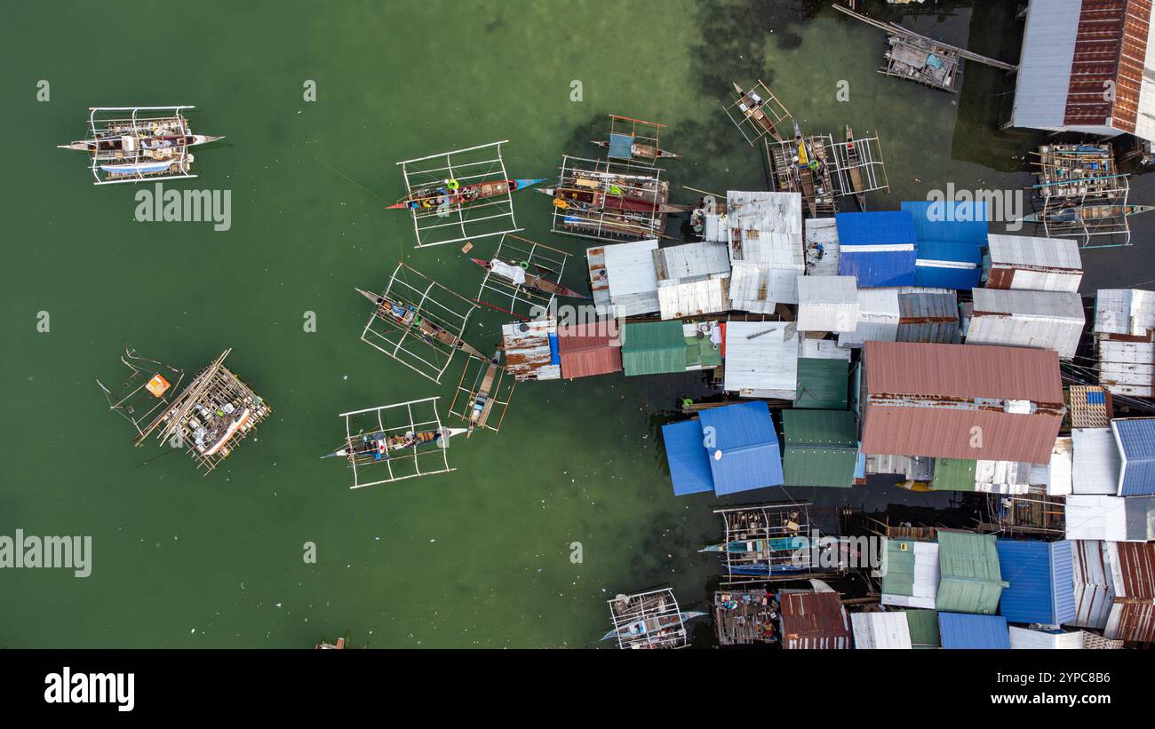 Fishing boats and stilt houses over the water in Bohol, Philippines ...