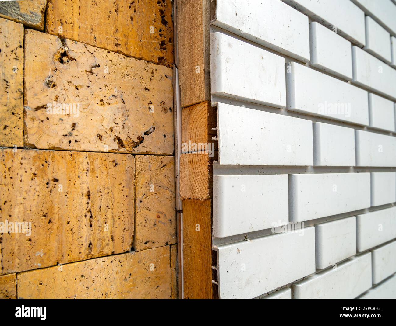 Installing panels with imitation brick on the wall of the house Stock ...