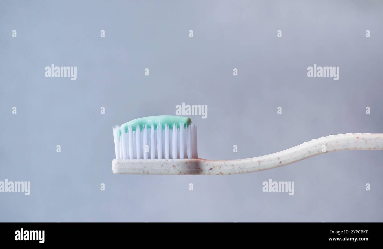 Close up an eco toothbrush with squeezed toothpaste on top, close up ...