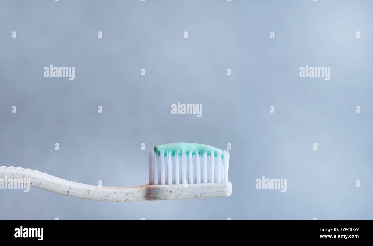 Close up an eco toothbrush with squeezed toothpaste on top, close up ...