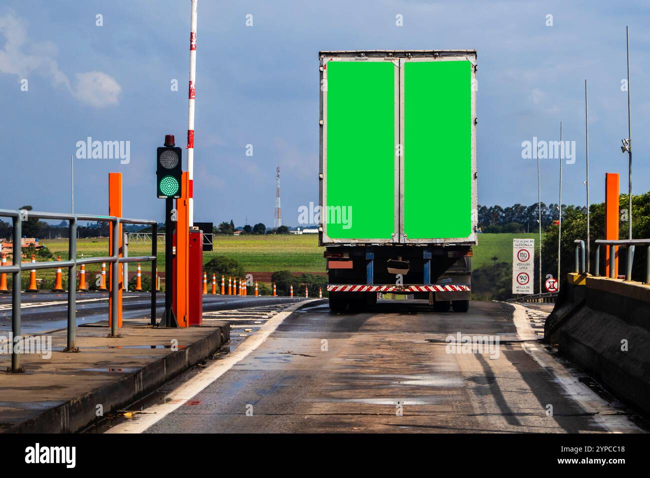 Green chromakey truck and container is on the pay toll checkpoint. Toll ...