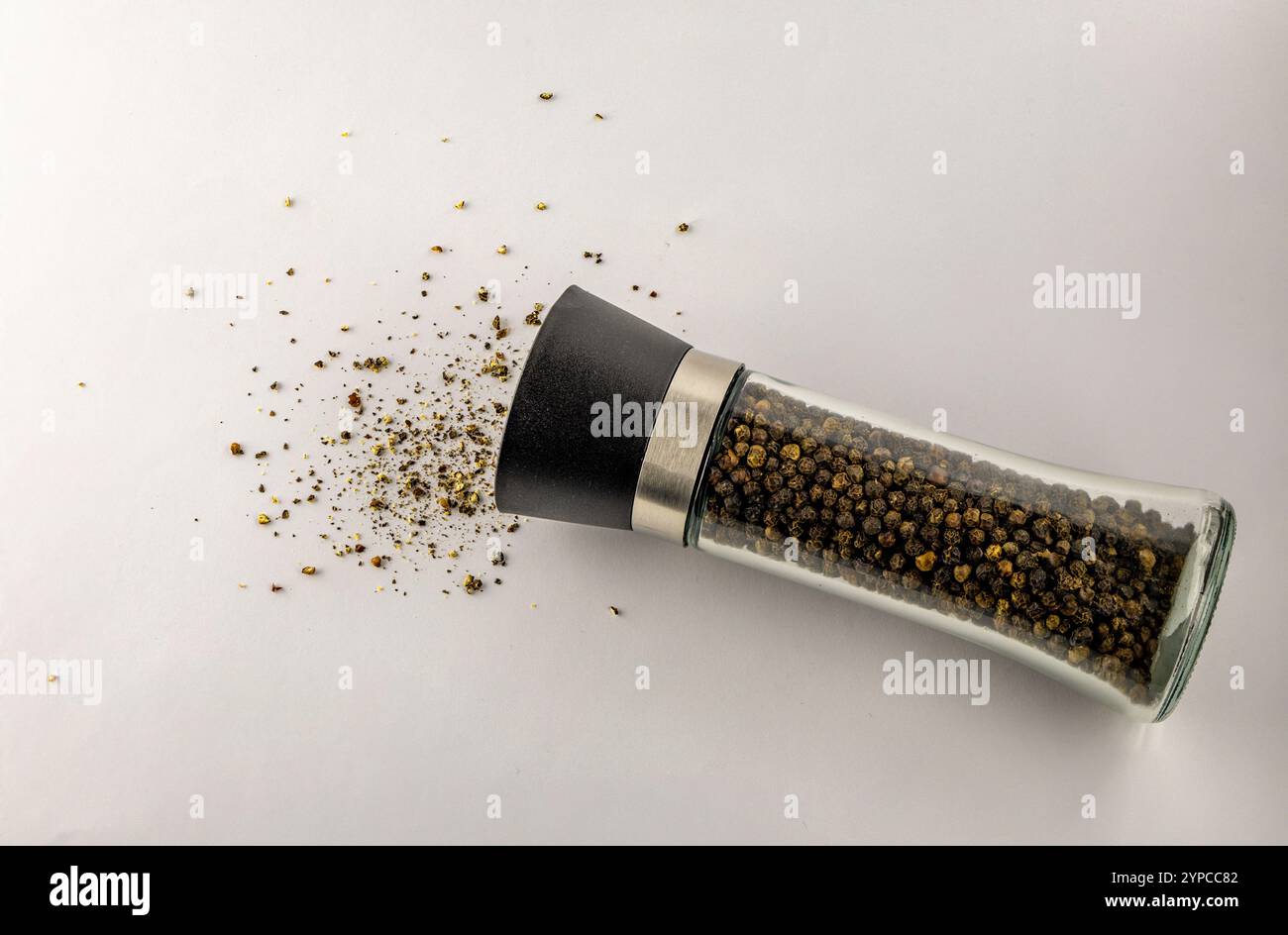 Salt and pepper in a glass container with a grinder, salt shaker ...
