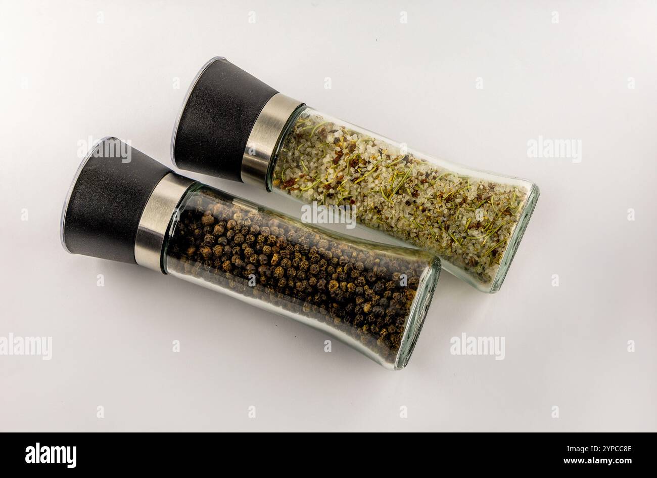 Salt and pepper in a glass container with a grinder, salt shaker ...