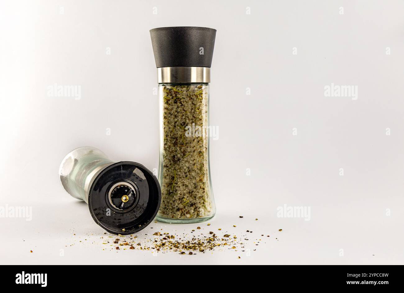 Salt and pepper in a glass container with a grinder, salt shaker ...