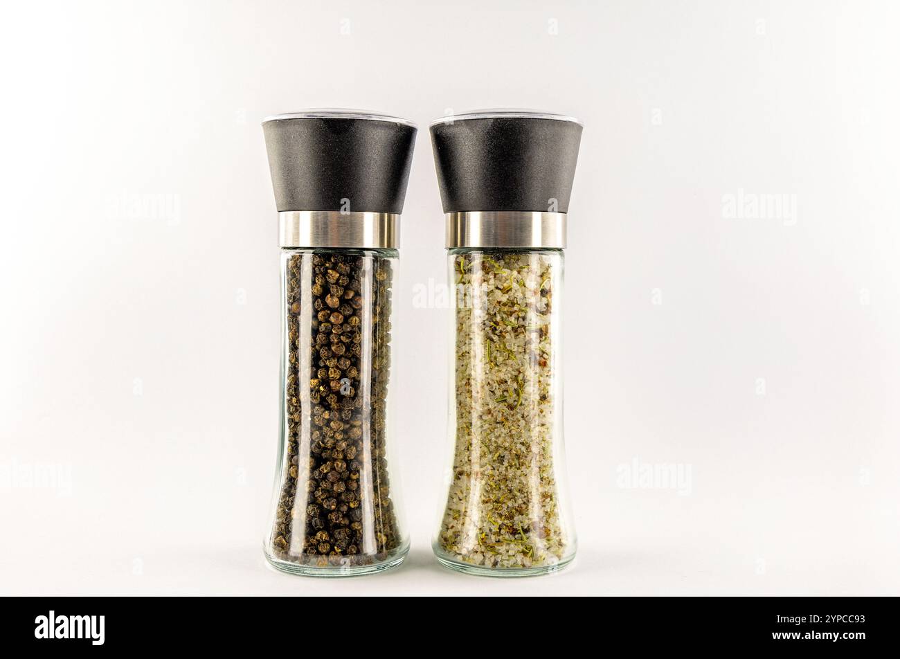 Salt and pepper in a glass container with a grinder, salt shaker ...