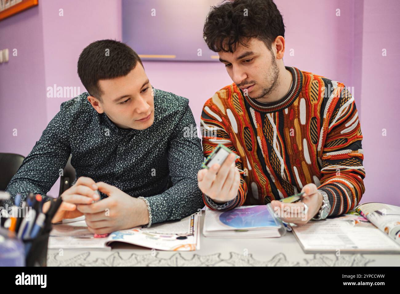 Two male students learning together at language school Stock Photo - Alamy