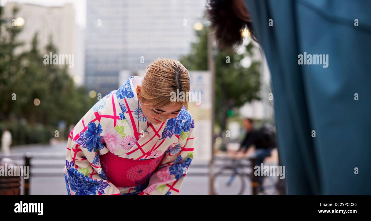 Bow, respect and woman in city for welcome, greeting and tradition with ...