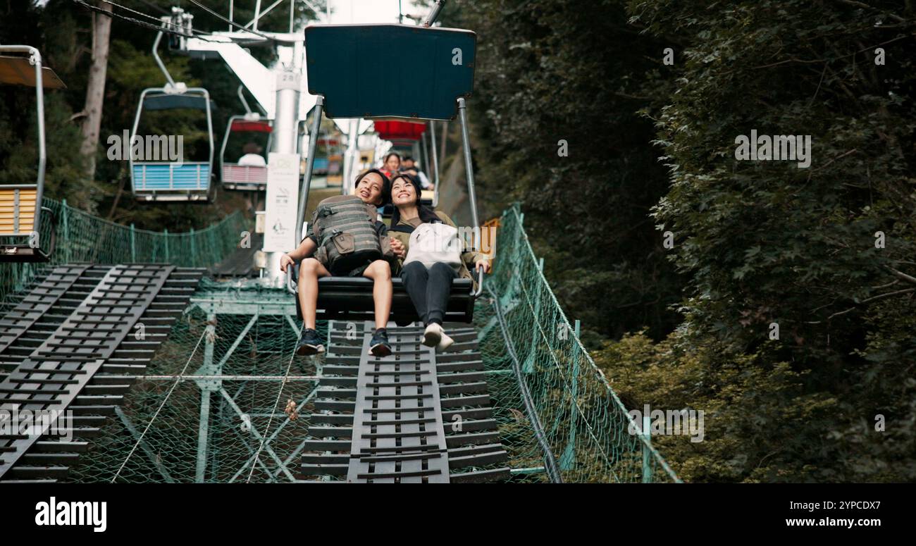 Mountain, travel and happy couple on chair lift for romantic date ...