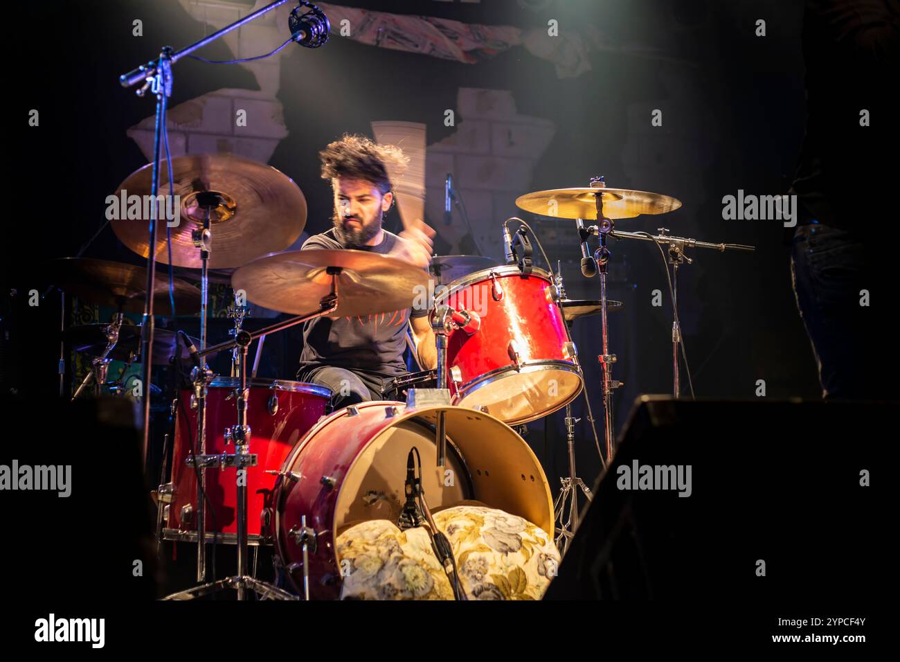Energetic Drummer Performing Live on Stage with Red Drum Set Stock ...