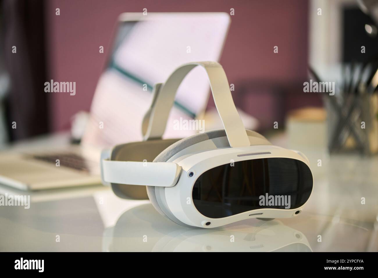 Virtual reality headset lying on workplace of modern white collar ...