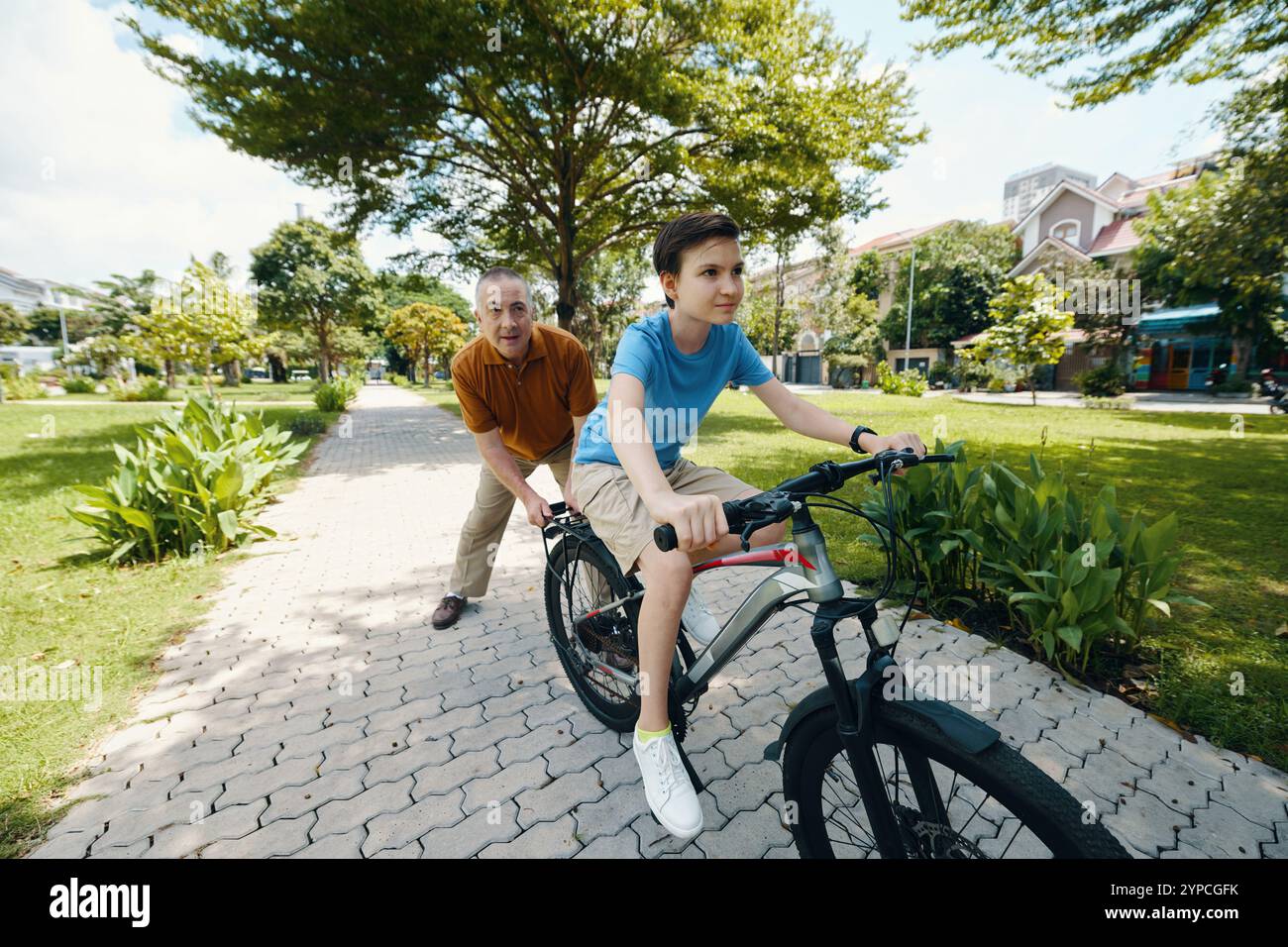 Little Boy Learning To Ride A Bike Stock Photo - Alamy
