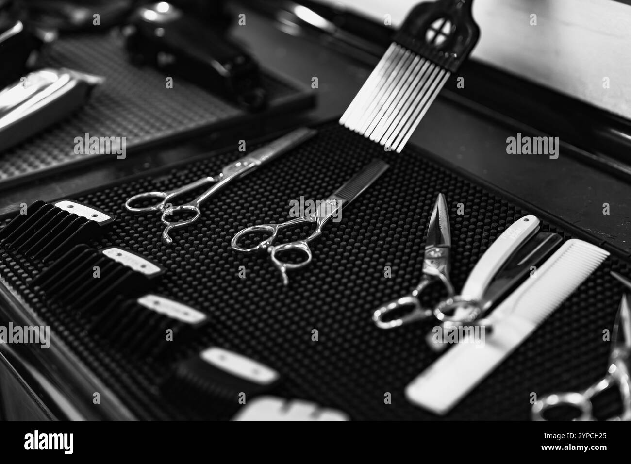 Sharp scissors and tools set on black textured surface in barbershop ...