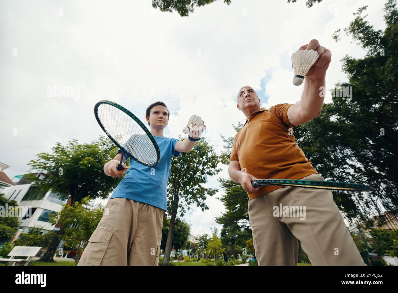 Family Playing Badminton In The Park Stock Photo - Alamy