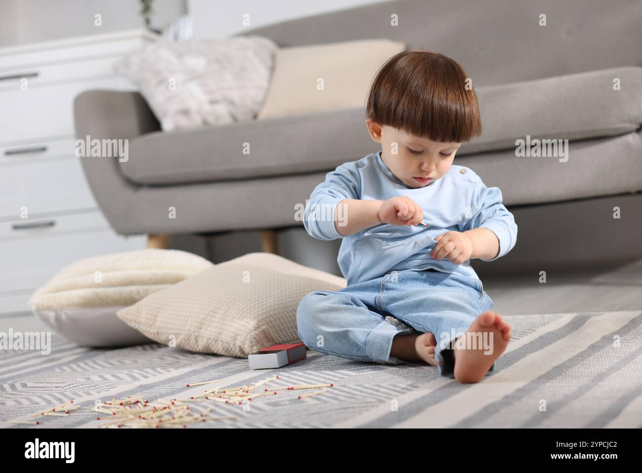 Little boy playing with matches at home. Child in danger Stock Photo ...