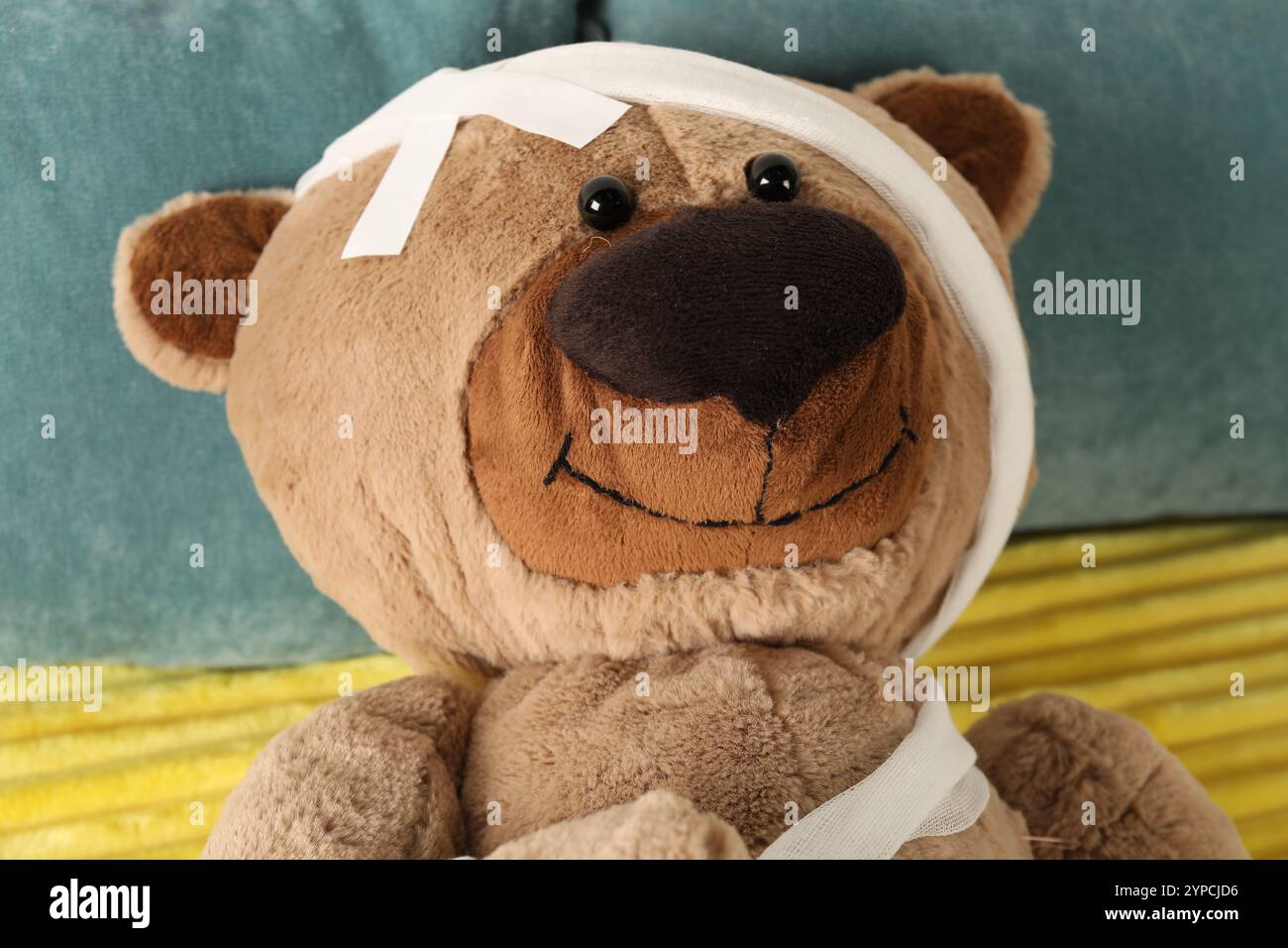 Cute teddy bear with bandages and adhesive medical plasters on bed ...