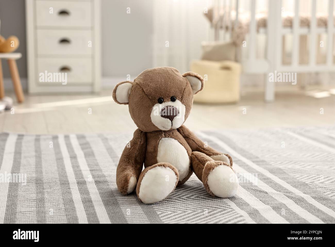 Cute teddy bear on floor in child room Stock Photo - Alamy