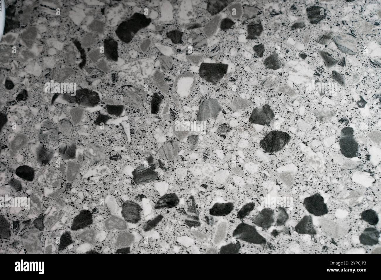 Textured surface of gray and white stone aggregate with natural ...