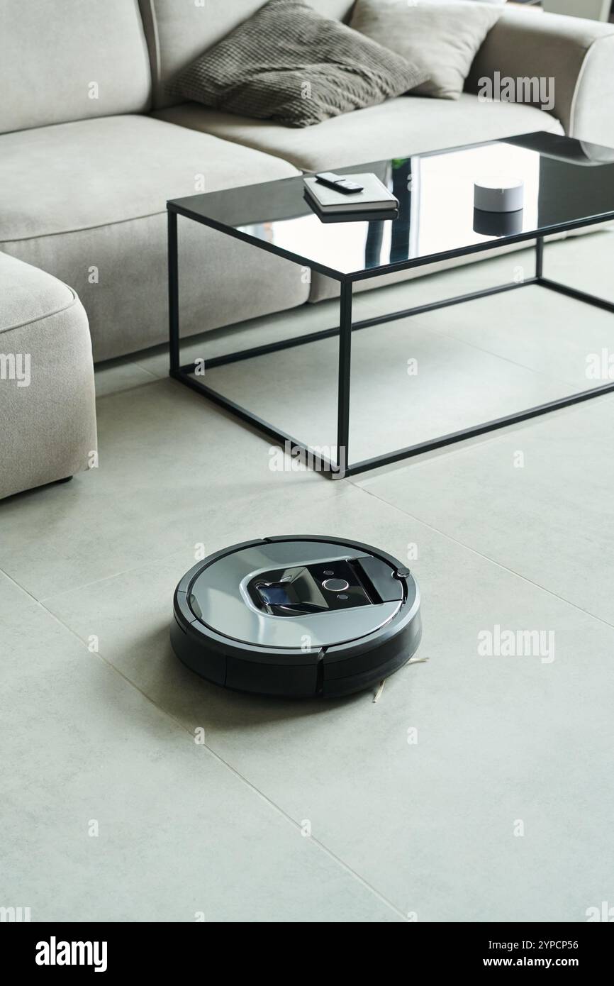 Robotic vacuum cleaner navigating through living room with modern ...